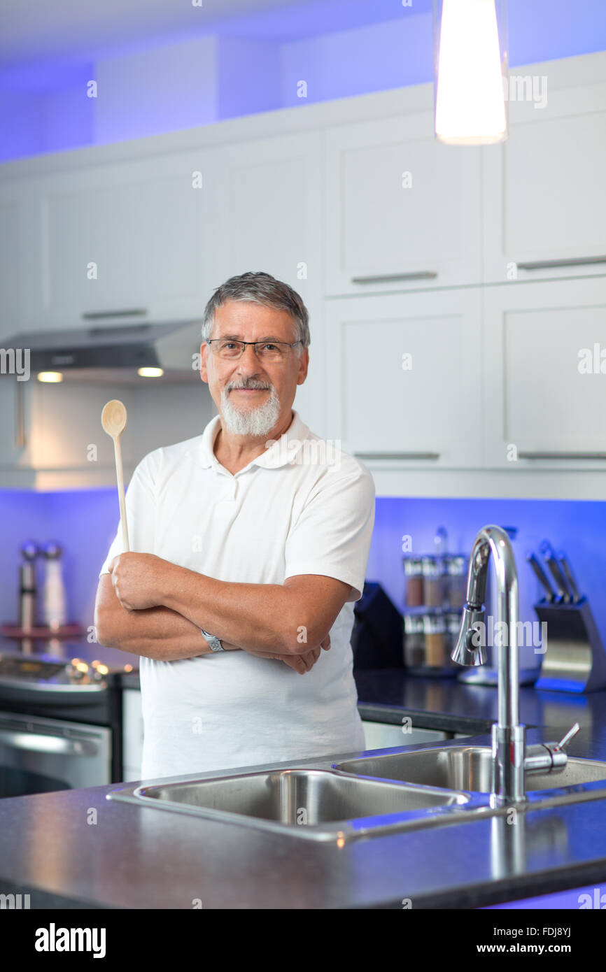 Senior man standing in his renovated, modern kitchen Stock Photo - Alamy