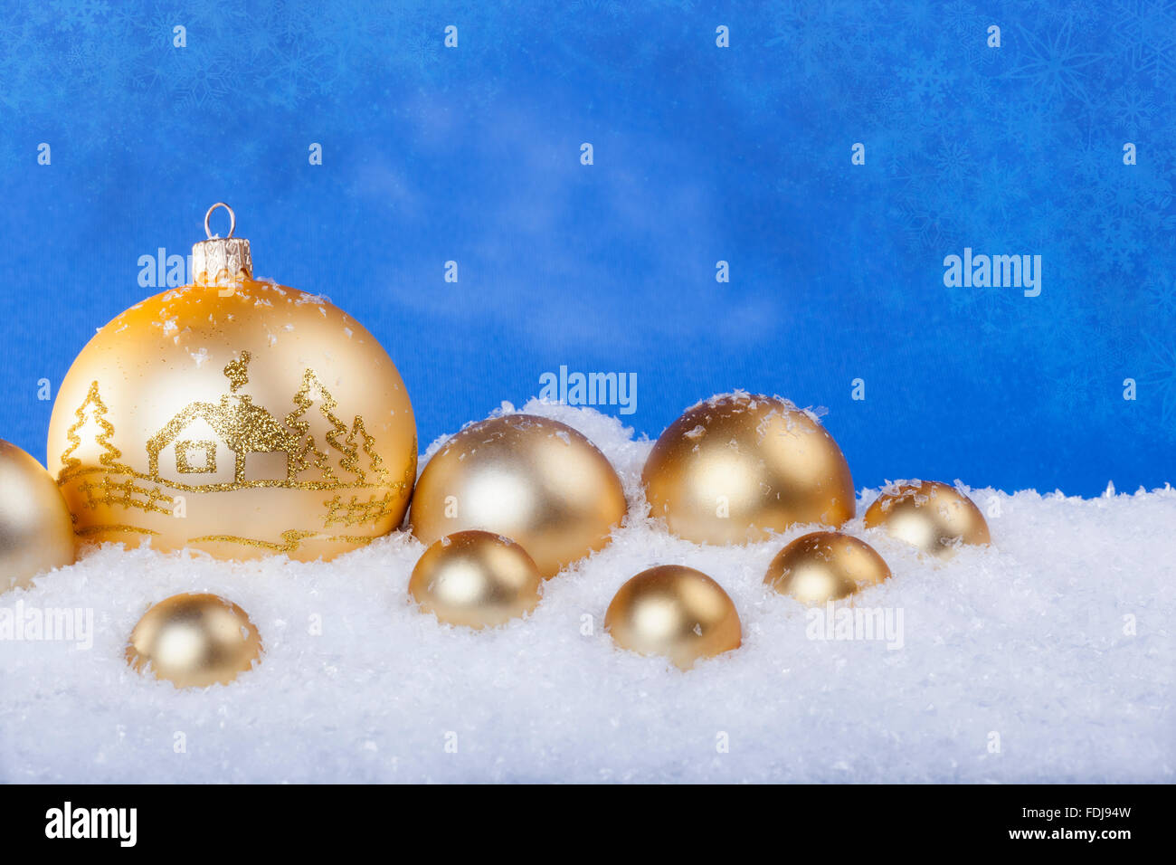 gold Christmas balls in the snow Stock Photo - Alamy