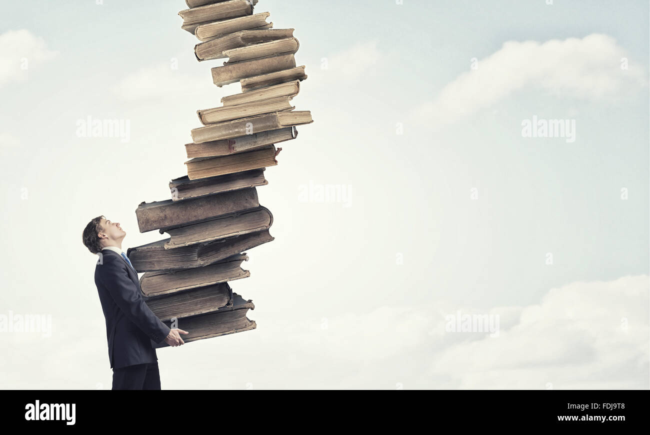 Man carrying stack old books hi-res stock photography and images - Alamy
