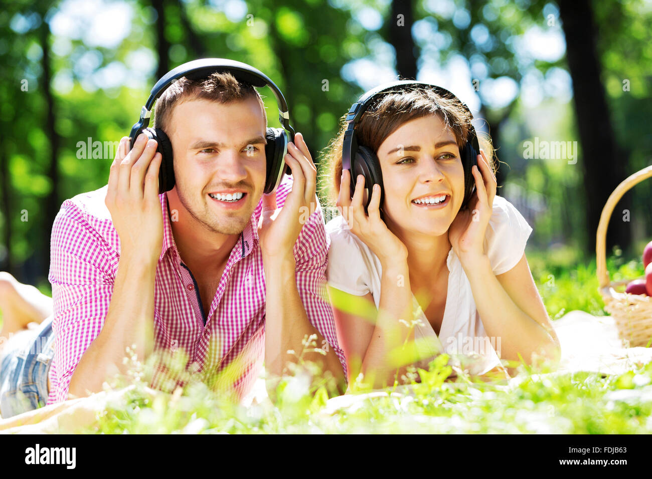 Loving young couple in summer park listening music Stock Photo - Alamy