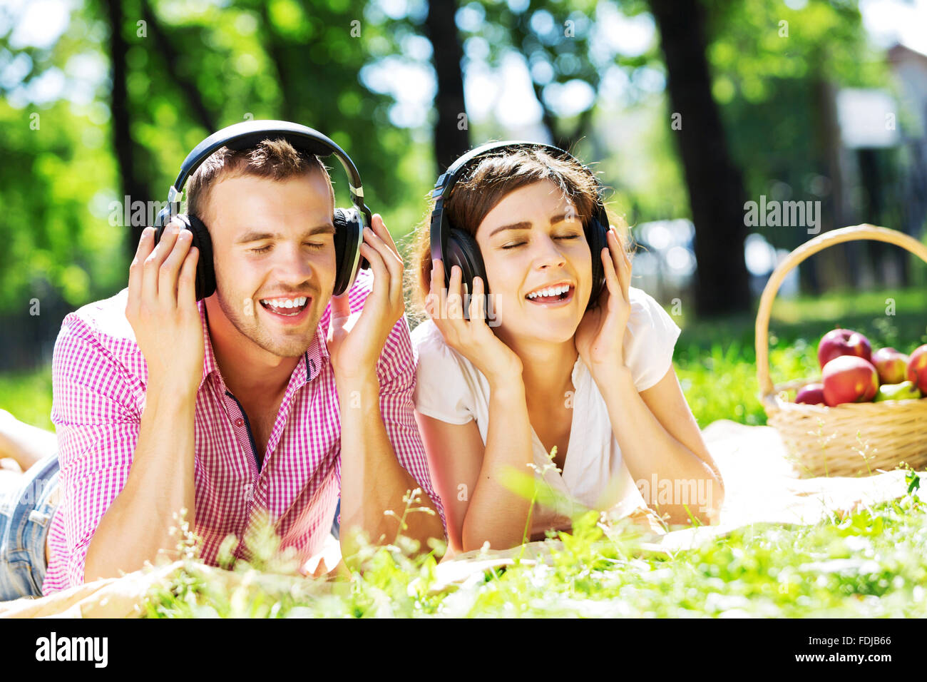 Loving young couple in summer park listening music Stock Photo - Alamy