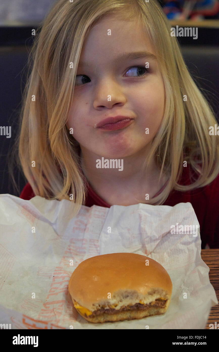 Adorable girl have meal in fast food restaurant Stock Photo - Alamy
