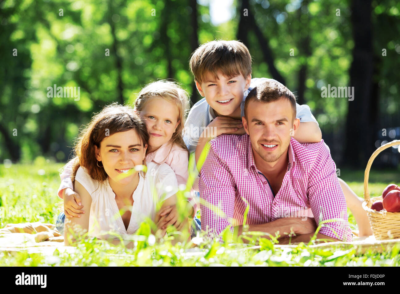 Happy family having weekend in summer park Stock Photo - Alamy