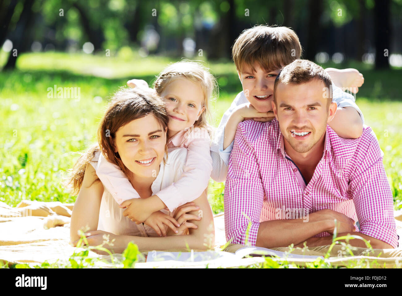 Happy family having weekend in summer park Stock Photo - Alamy