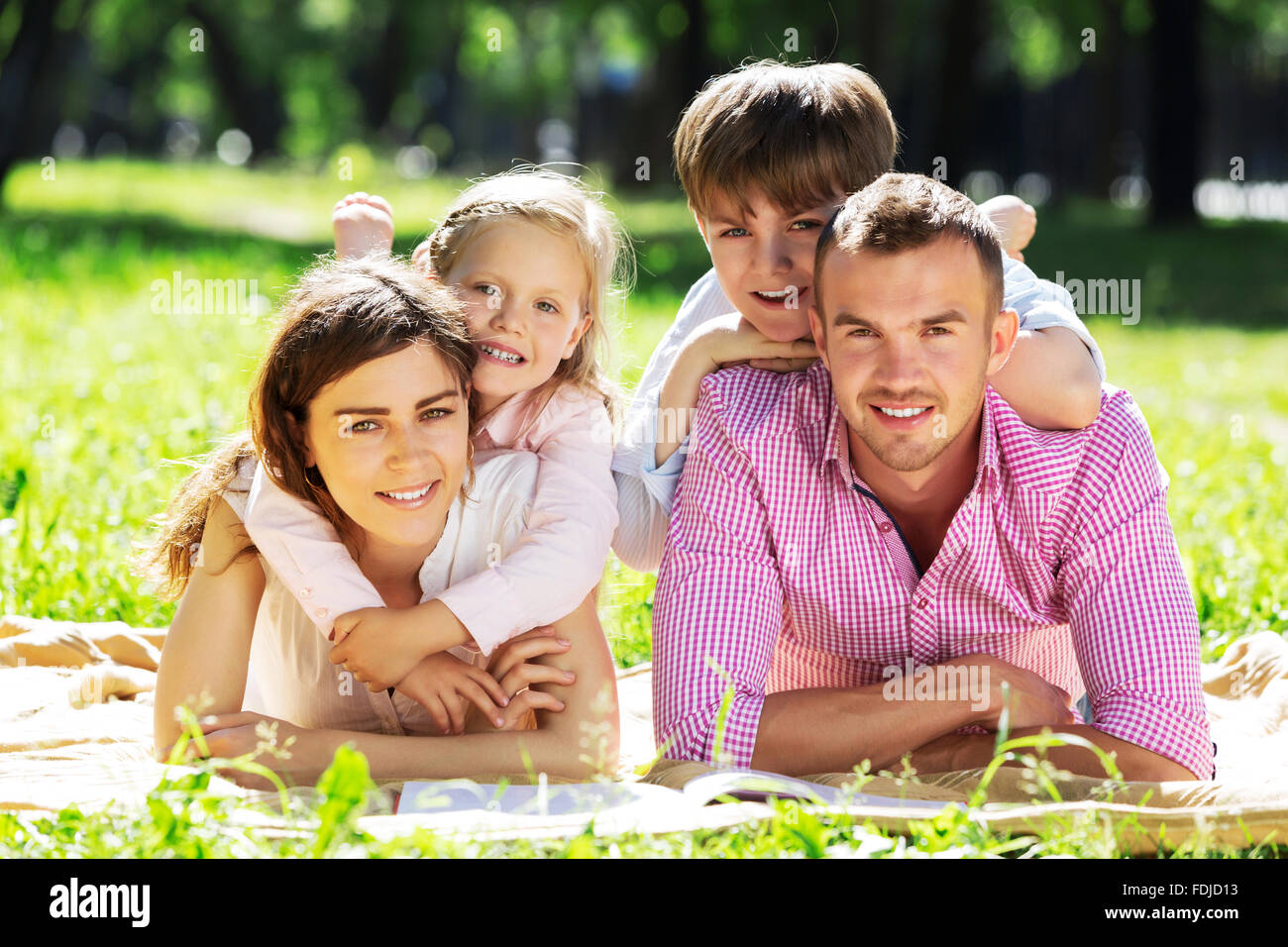Happy family having weekend in summer park Stock Photo - Alamy
