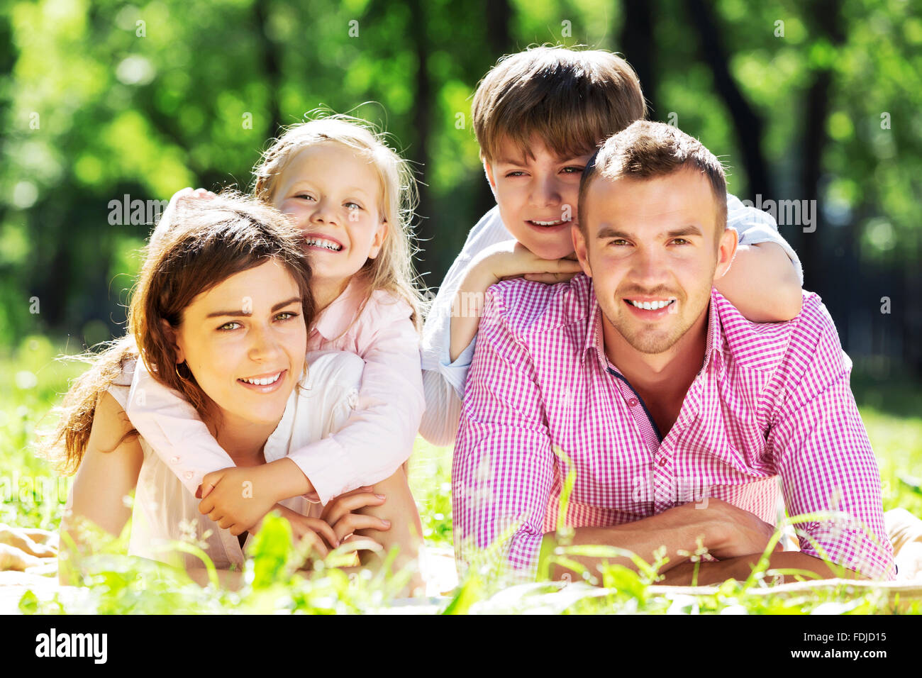 Happy family having weekend in summer park Stock Photo - Alamy