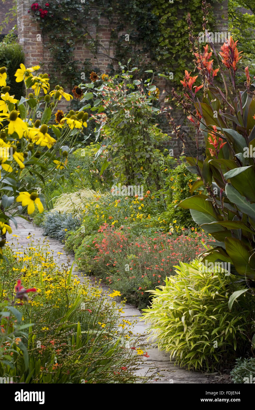 Red and yellow planting in late August in the Cottage Garden at ...