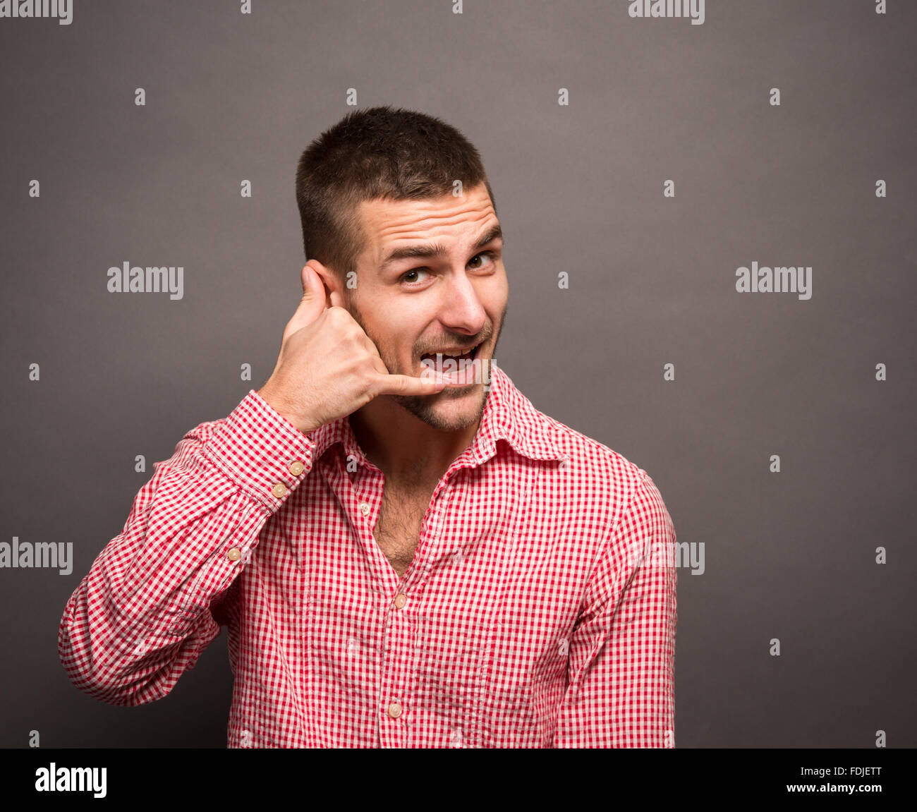 Man making phone gesture Stock Photo - Alamy