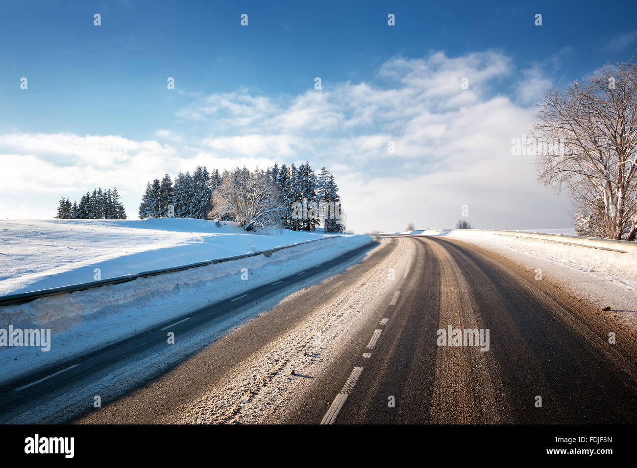 Asphalt road in snowy winter on beautiful sunny day Stock Photo - Alamy