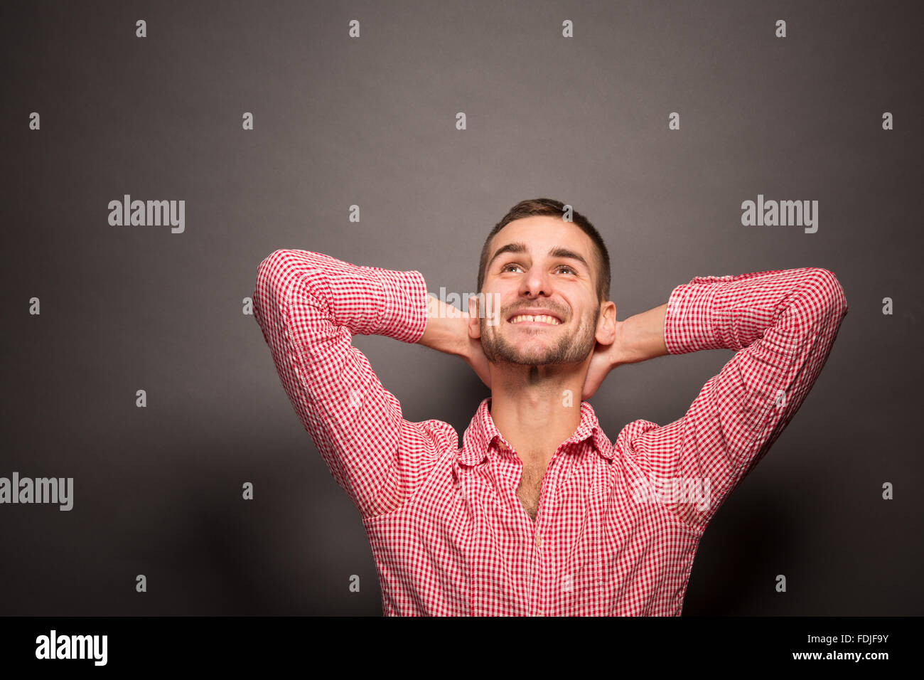 Handsome man looking upwards in studio Stock Photo - Alamy
