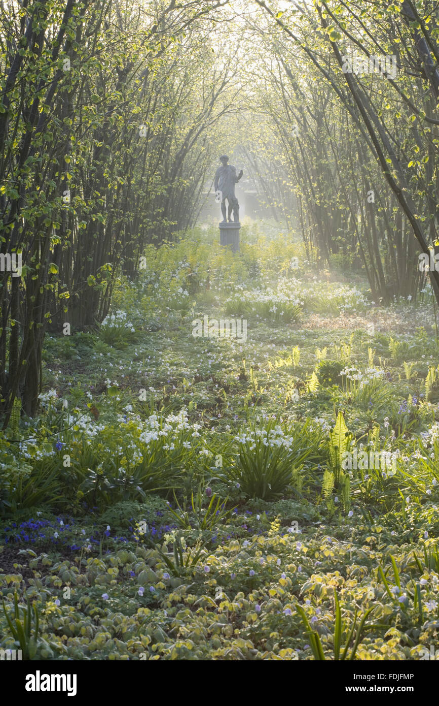 Statue of Dionysus in the Nuttery in spring at Sissinghurst Castle ...