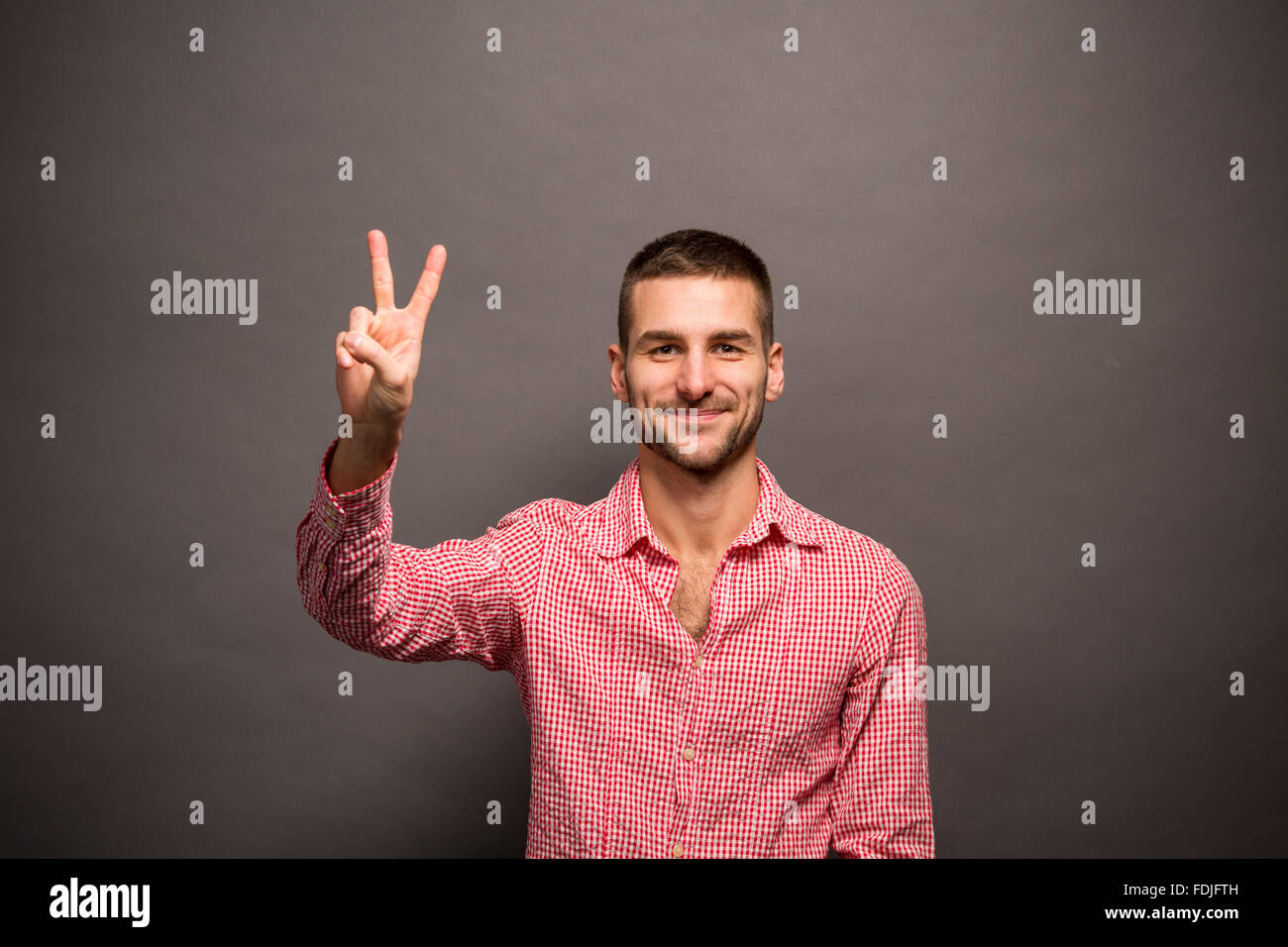 Handsome man showing okay sign Stock Photo - Alamy