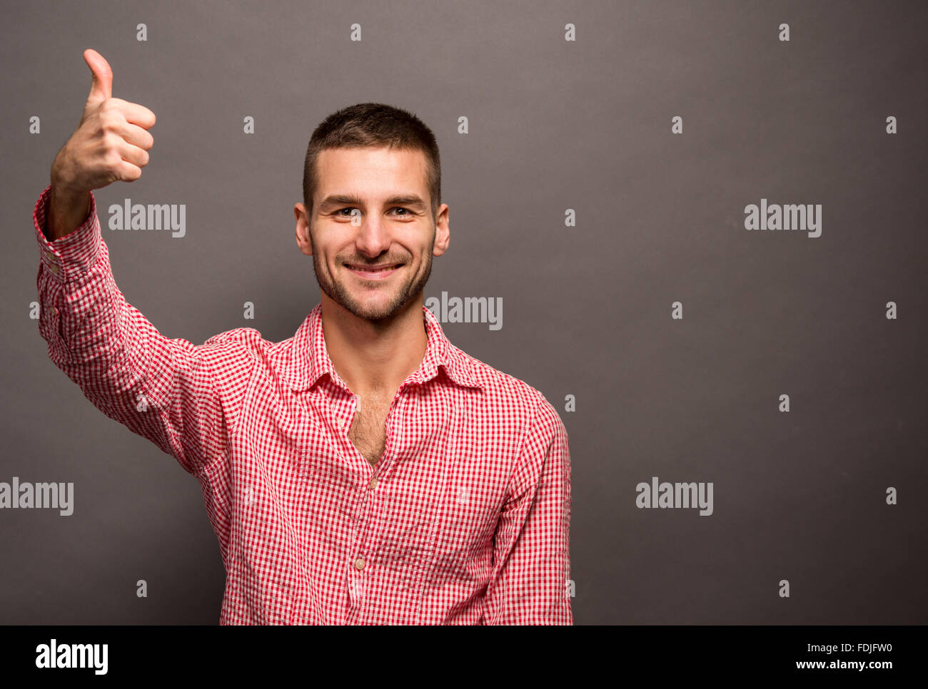 Handsome man showing thumb-up Stock Photo - Alamy