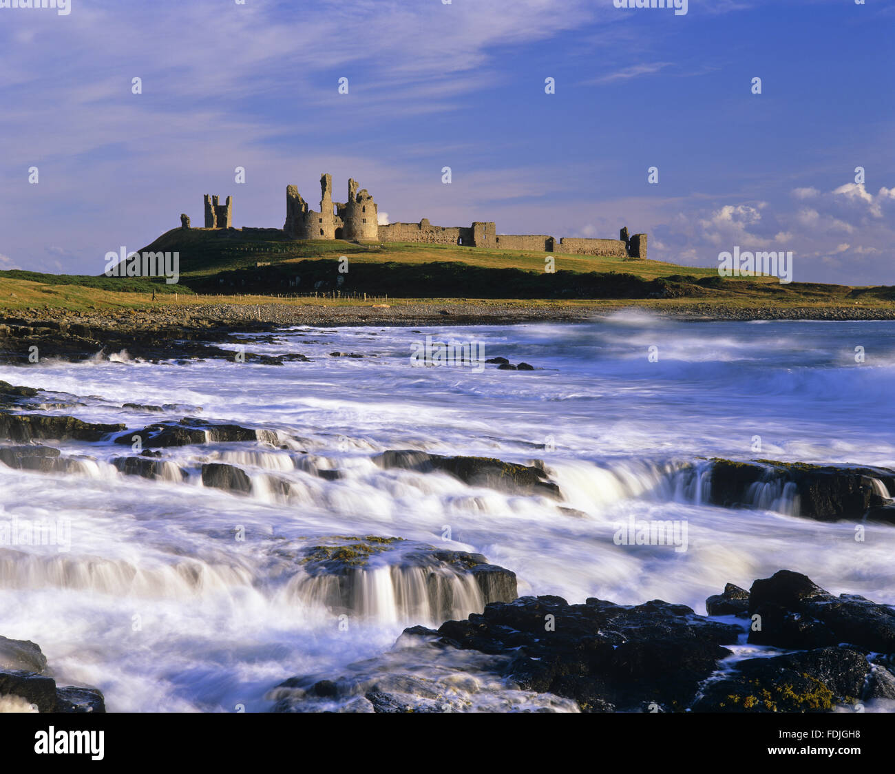 Dunstanburgh Castle, Northumberland seen from the beach at Craster with ...