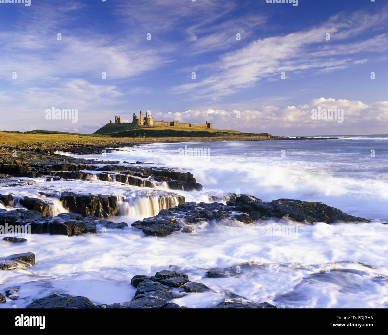 Dunstanburgh Castle, Northumberland on the horizon with the beach at ...