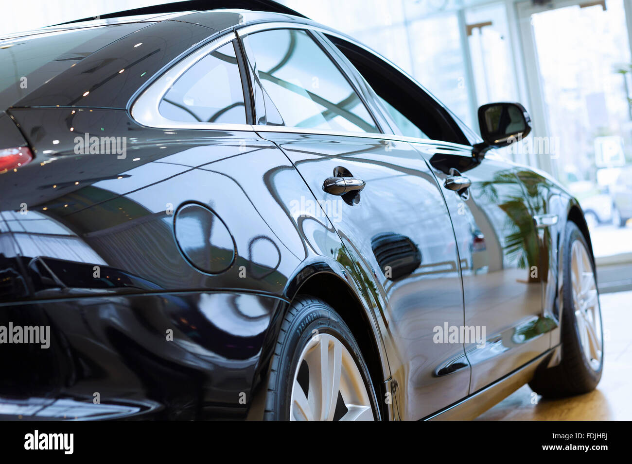 Back view of automobile in sales salon Stock Photo - Alamy