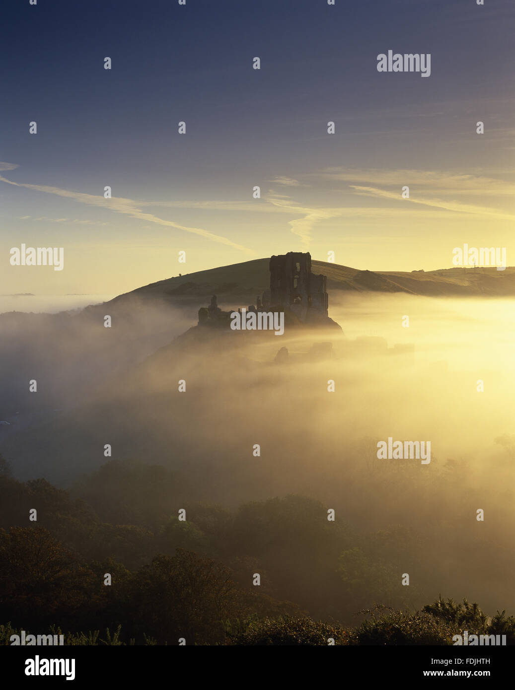 The silhouette of medieval Corfe Castle in the dawn mist, Dorset Stock ...