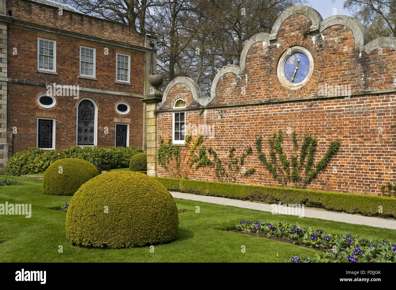 The cusped gable wall with clock brought from Stansty Park, and the ...