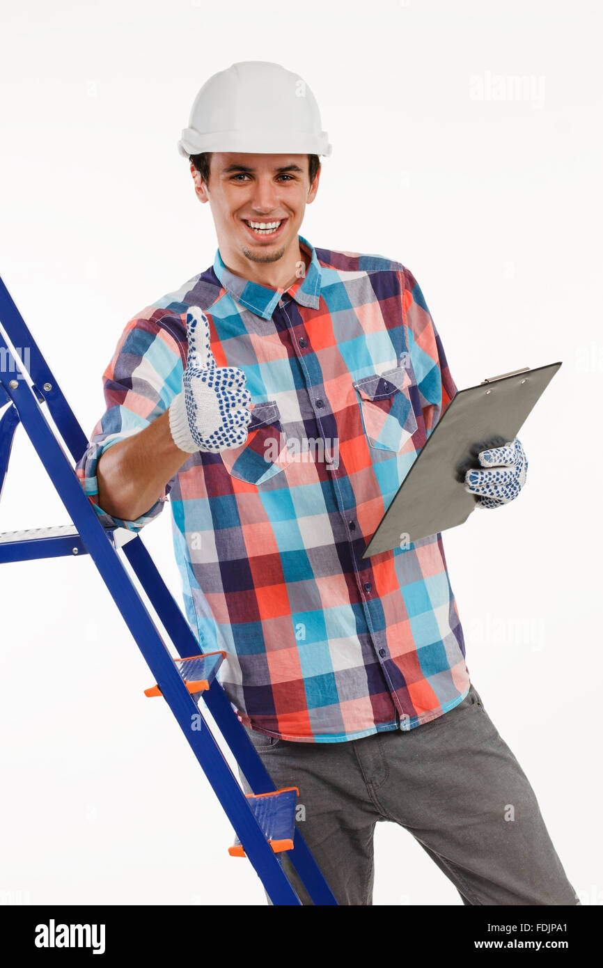 Handyman stood by ladder giving thumbs-up Stock Photo - Alamy