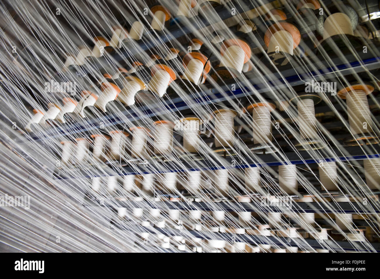 A view of a creel holding the bobbins used for warping which prepares ...