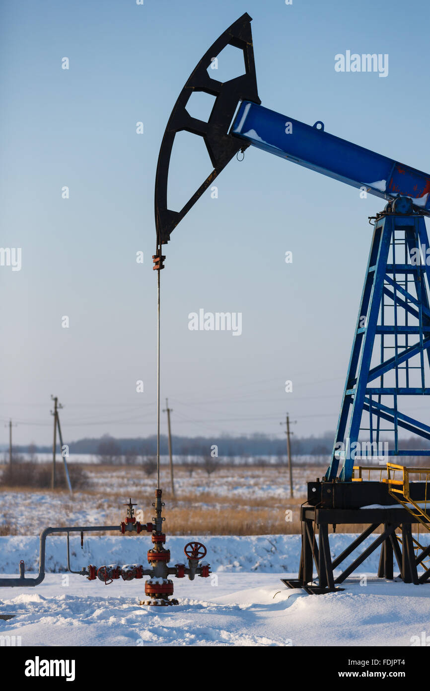 Oil derricks on snowy field at winter time Stock Photo - Alamy
