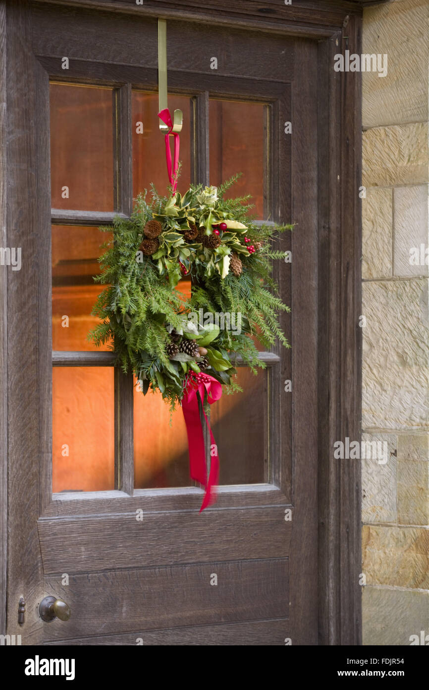 Traditional Victorian Christmas wreath on the front door at Standen ...