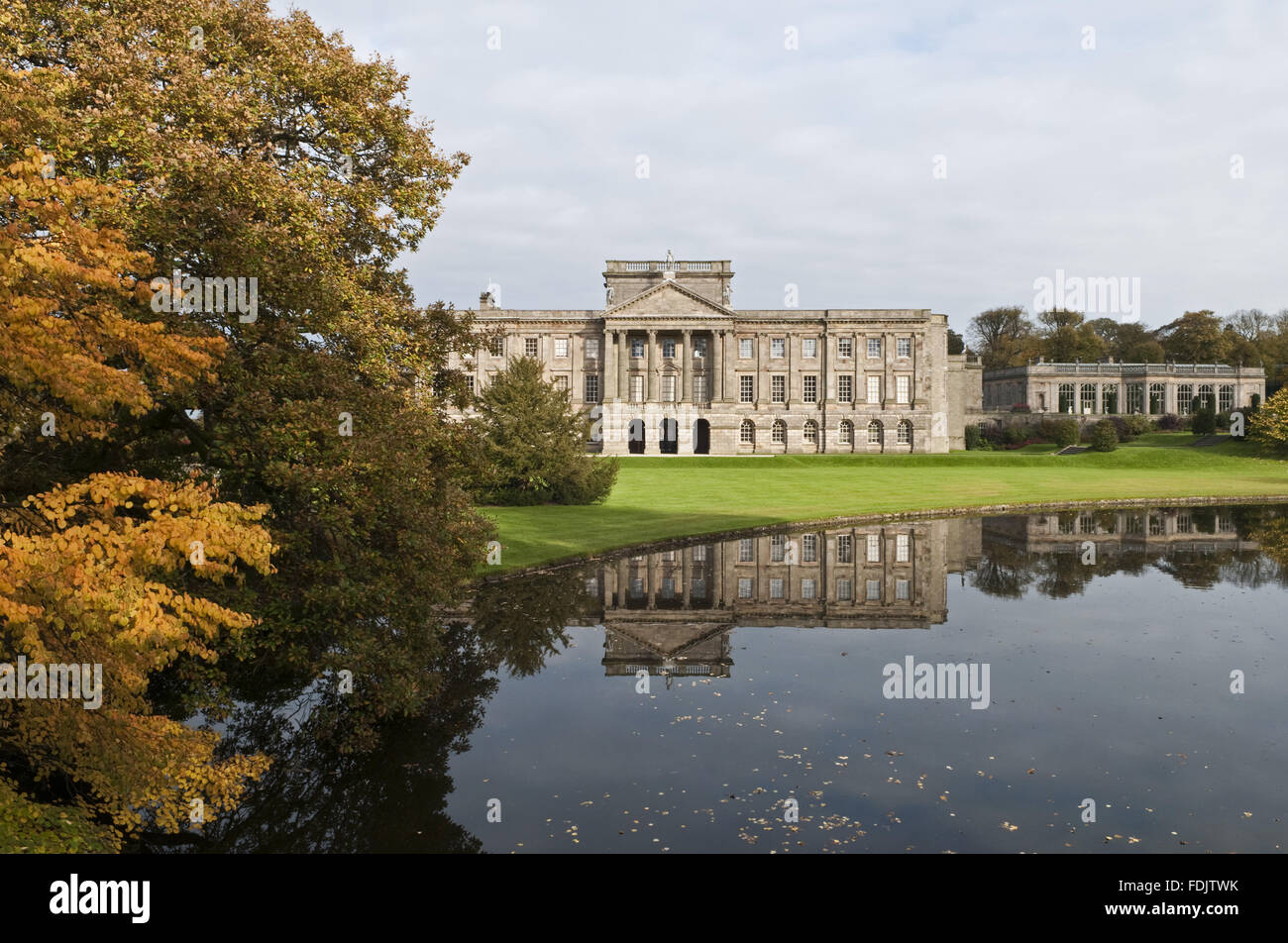 The south front of Lyme Park, Cheshire, seen across the lake, in autumn ...