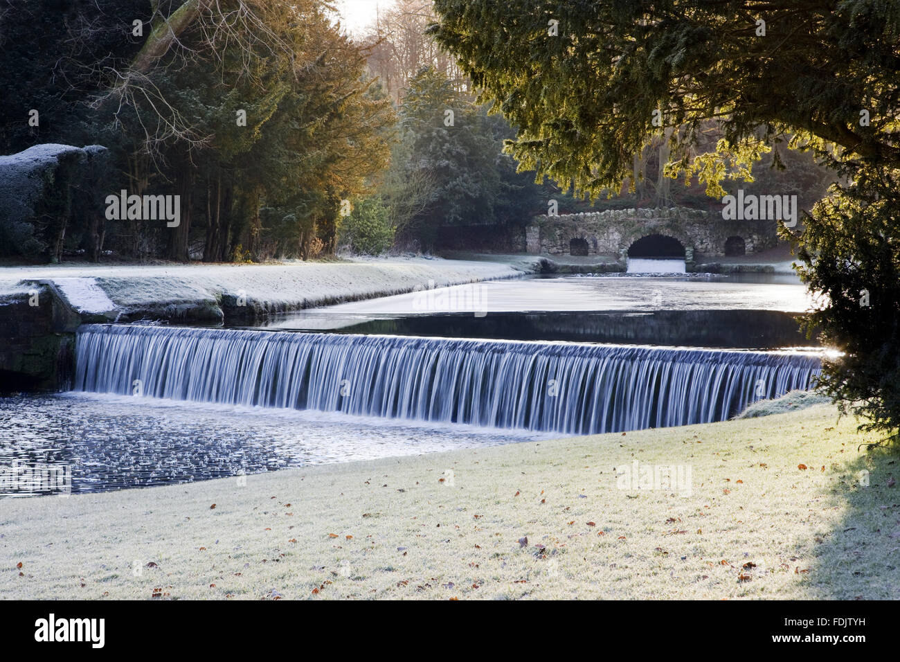 The Drum Fall and Rustic Bridge in winter at Studley Royal Water Garden ...
