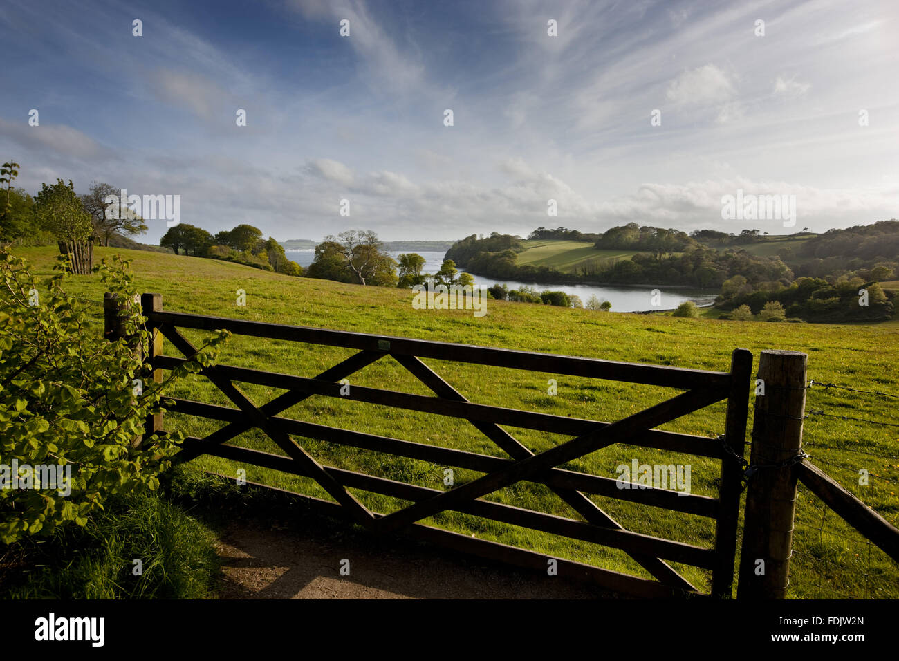 A view over a five-barred gate towards the Carrick Roads, south of ...