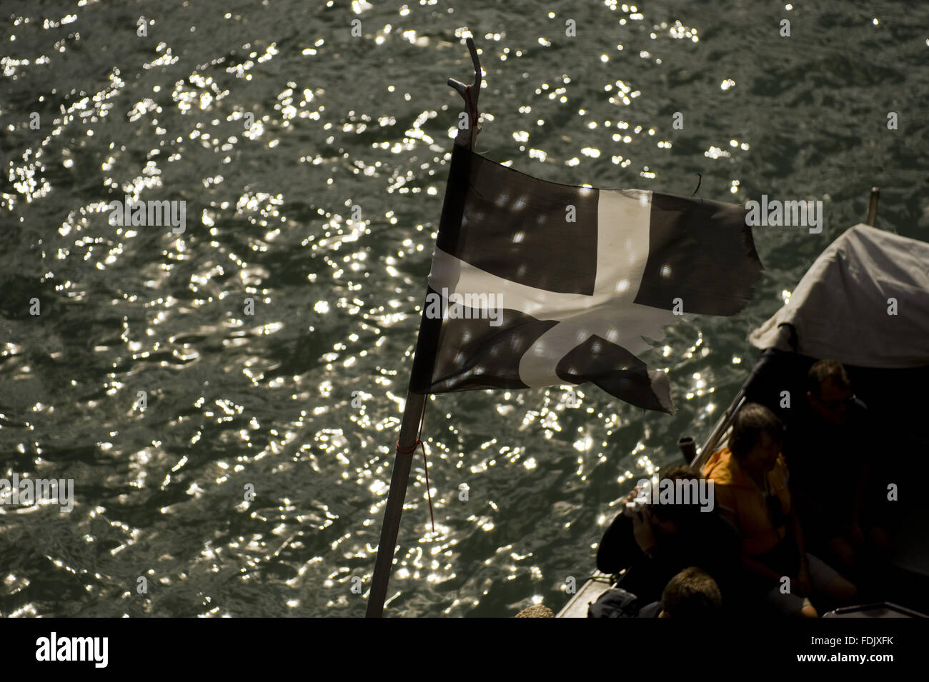 The Cornish flag fluttering from a boat, West Penwith, Cornwall Stock ...
