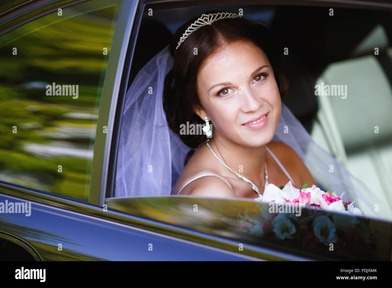 Bride in a car in her wedding day Stock Photo - Alamy