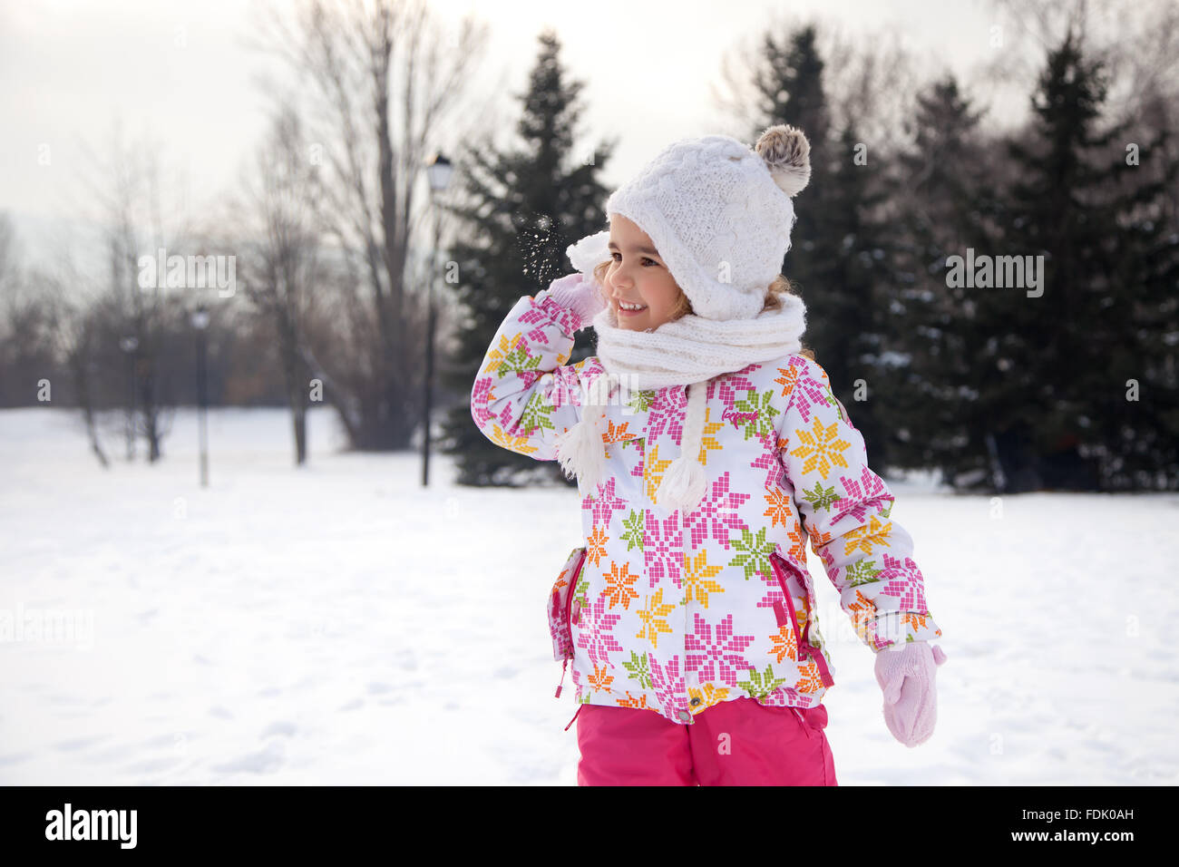 Girl throwing a snowball Stock Photo - Alamy