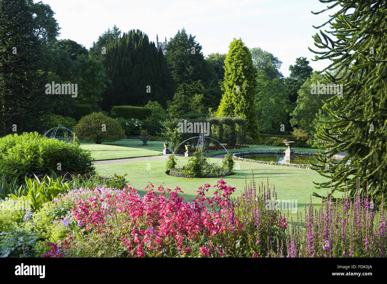 The middle terrace with the circular pond and the ironwork framed beds ...