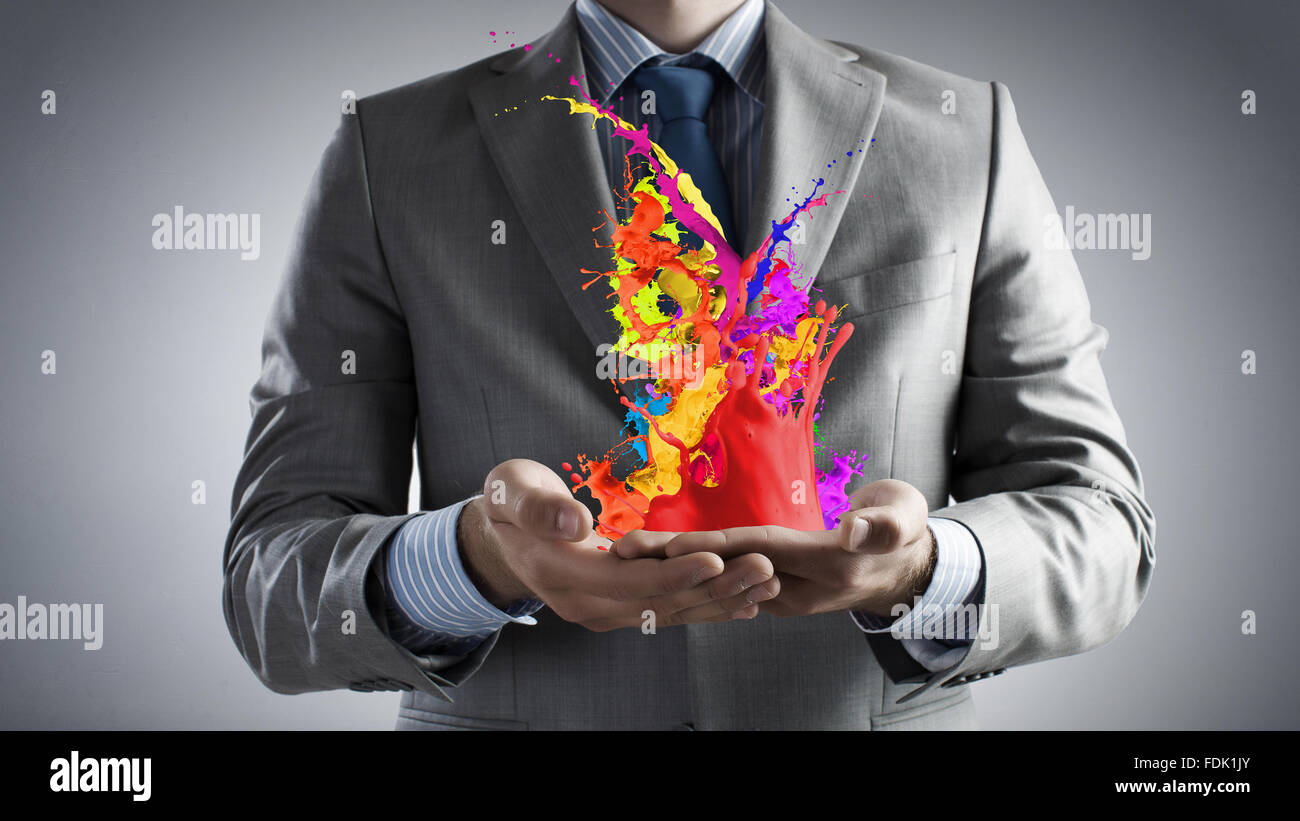 Male hands holding paint splashes and icons in palms Stock Photo - Alamy