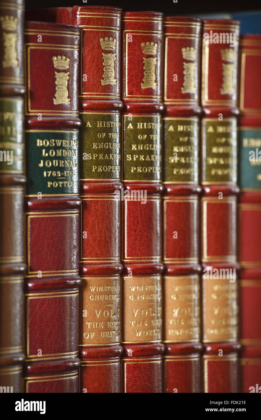 Leather-bound books on shelves in the Library at Anglesey Abbey ...