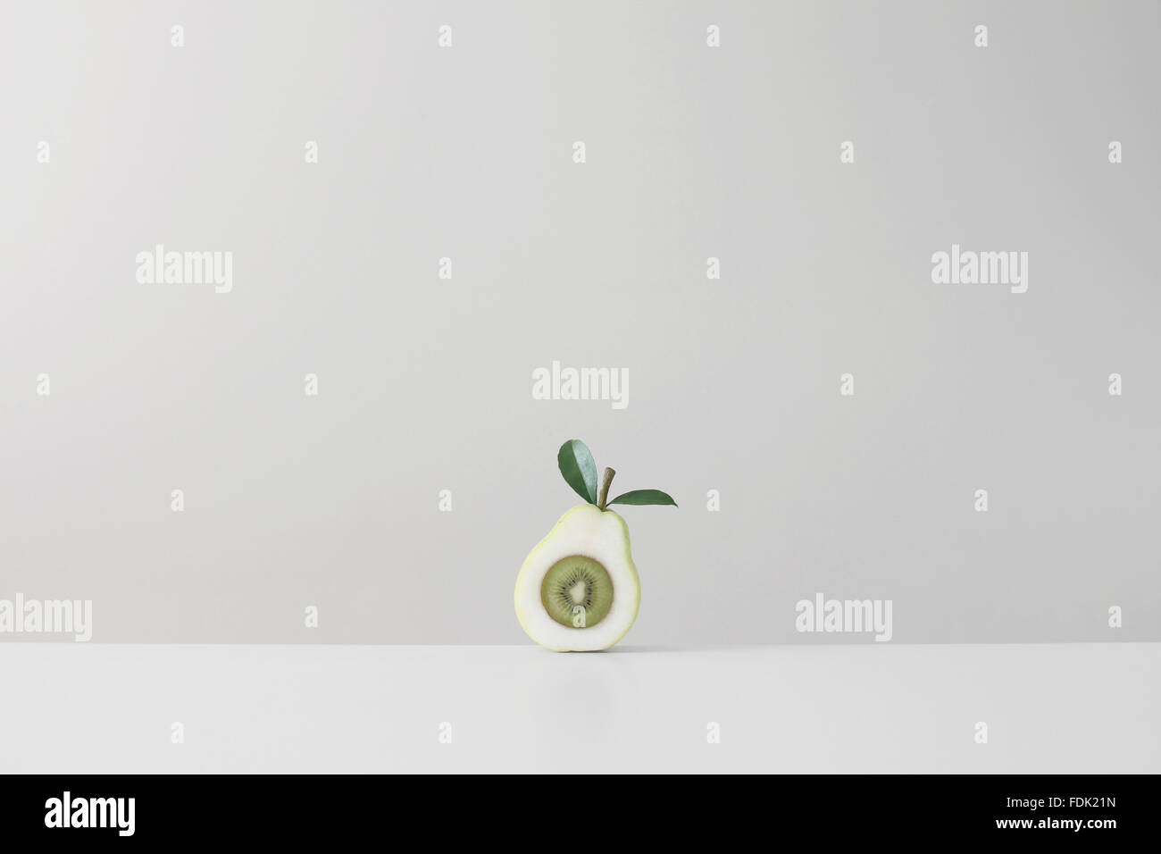 Kiwi fruit inside halved pear Stock Photo - Alamy