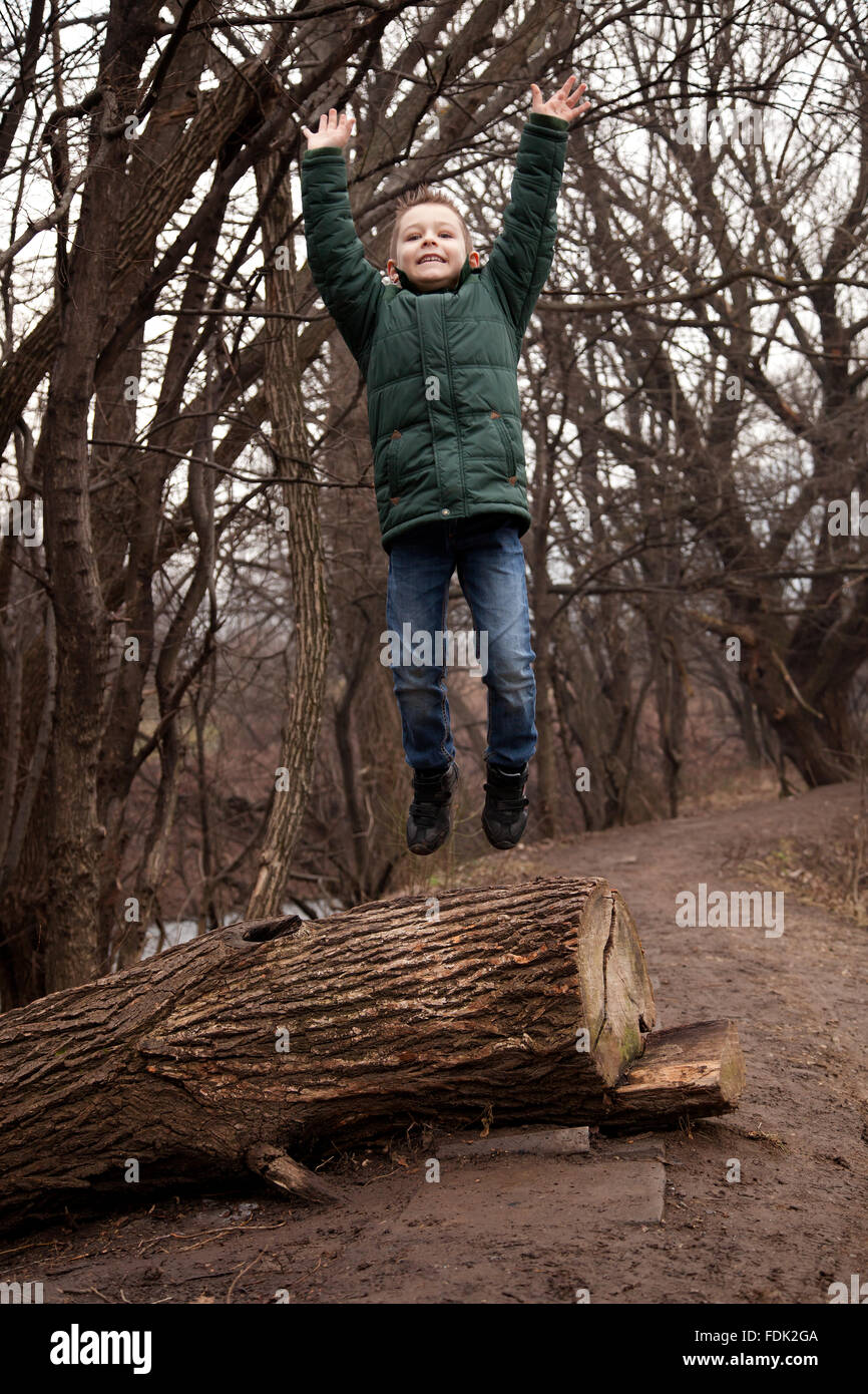 Boy jumping off tree hi-res stock photography and images - Alamy