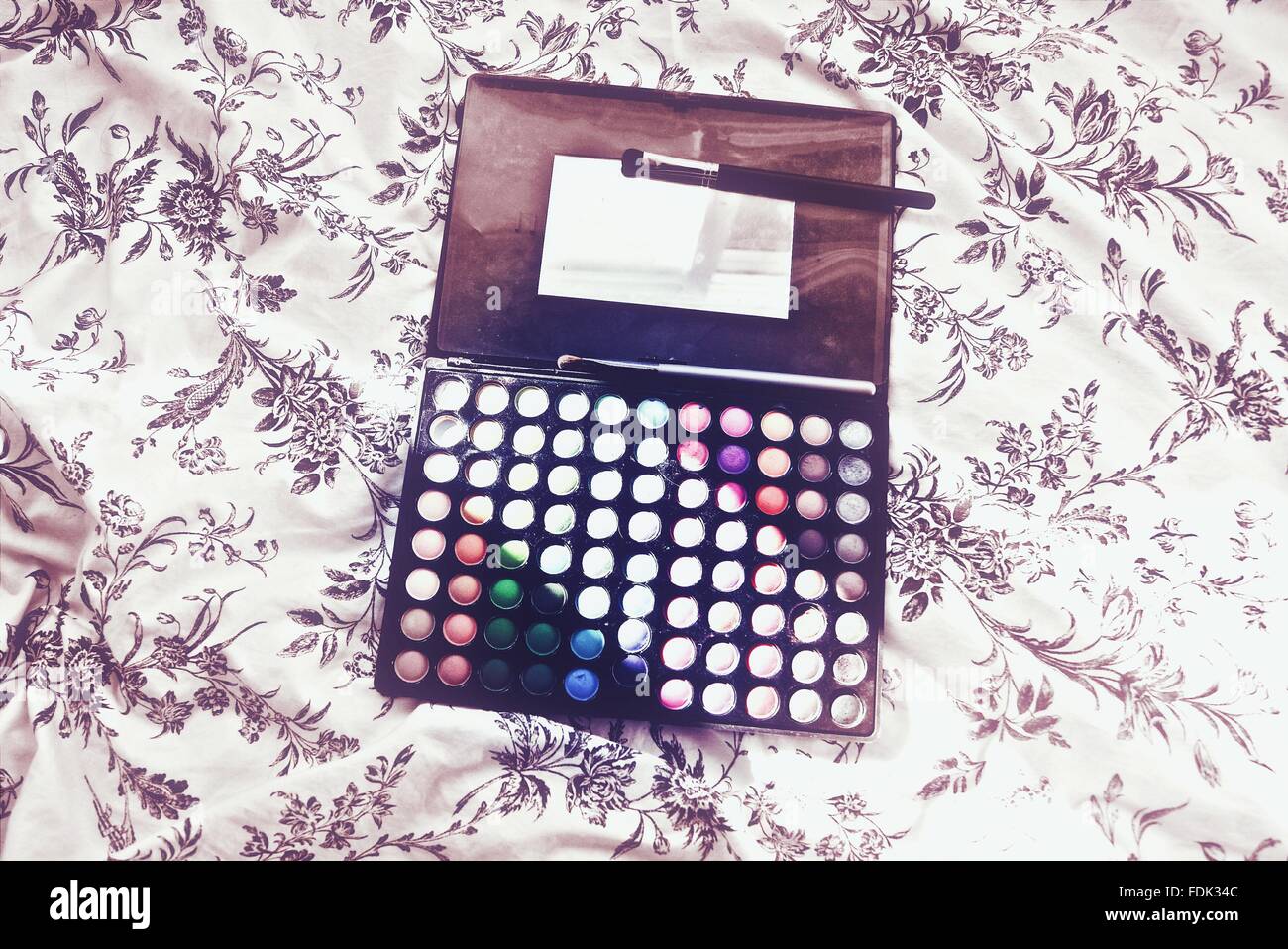 Elevated view of eye shadow pallet on bed Stock Photo - Alamy