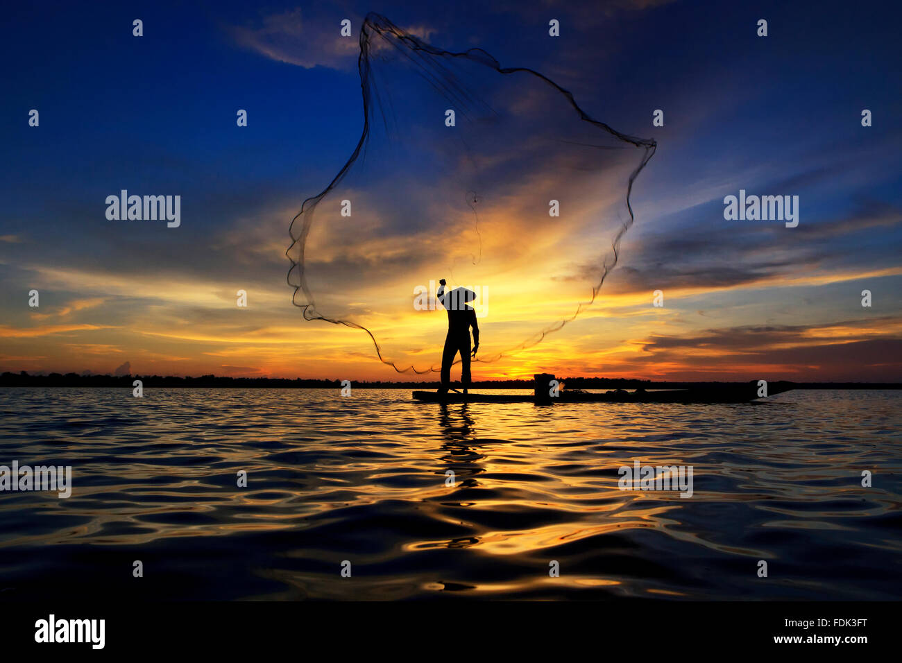 Man throwing fishing net into water hi-res stock photography and images ...
