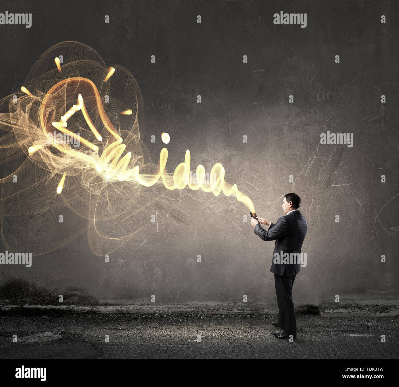 Businessman using his tablet pc and glowing light out of screen Stock ...