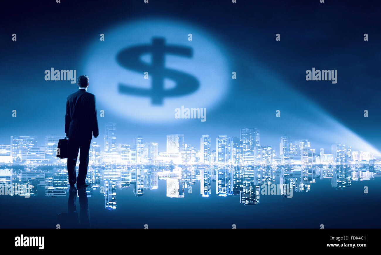 Businessman standing with back in darkness and dollar sign in ...