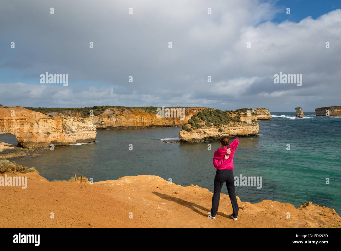 Rear view of woman stretching, Torquay, Victoria, Australia Stock Photo ...