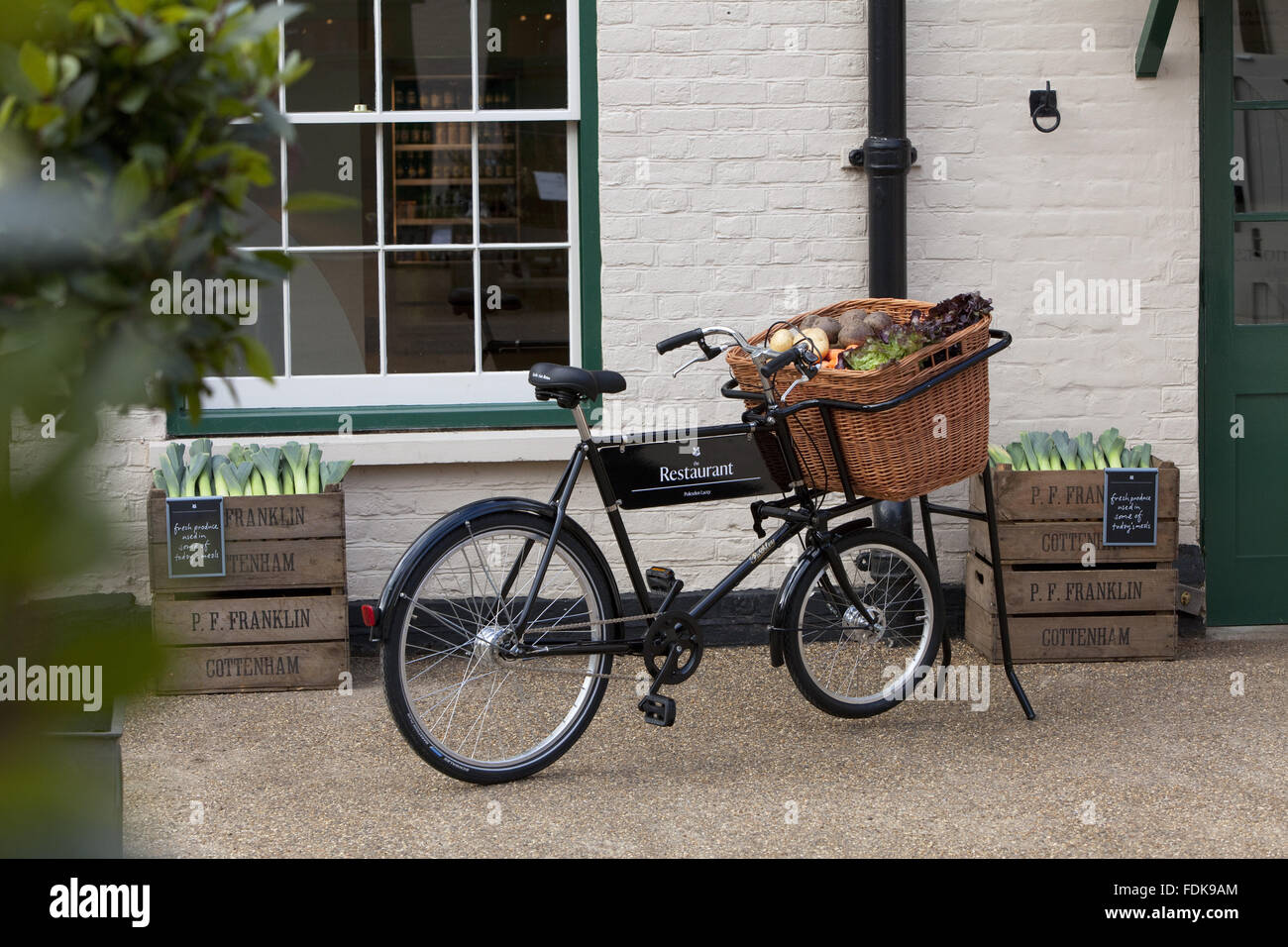 A traditional delivery bicycle with a basket on display outside ...