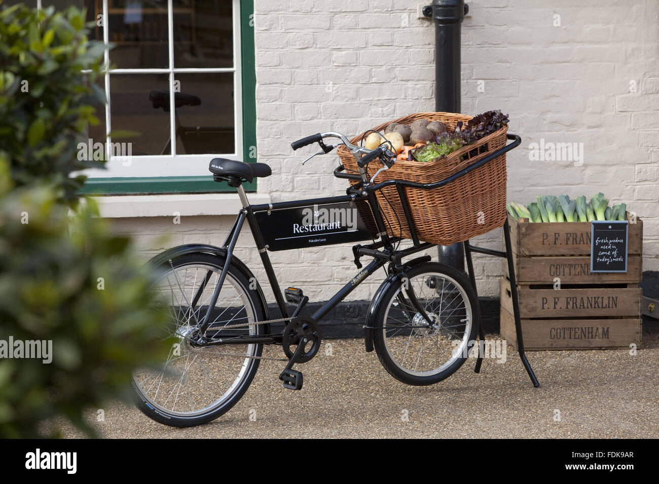 A traditional delivery bicycle with a basket on display outside ...