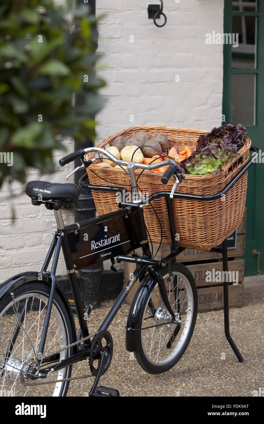 A traditional delivery bicycle with a basket on display outside ...