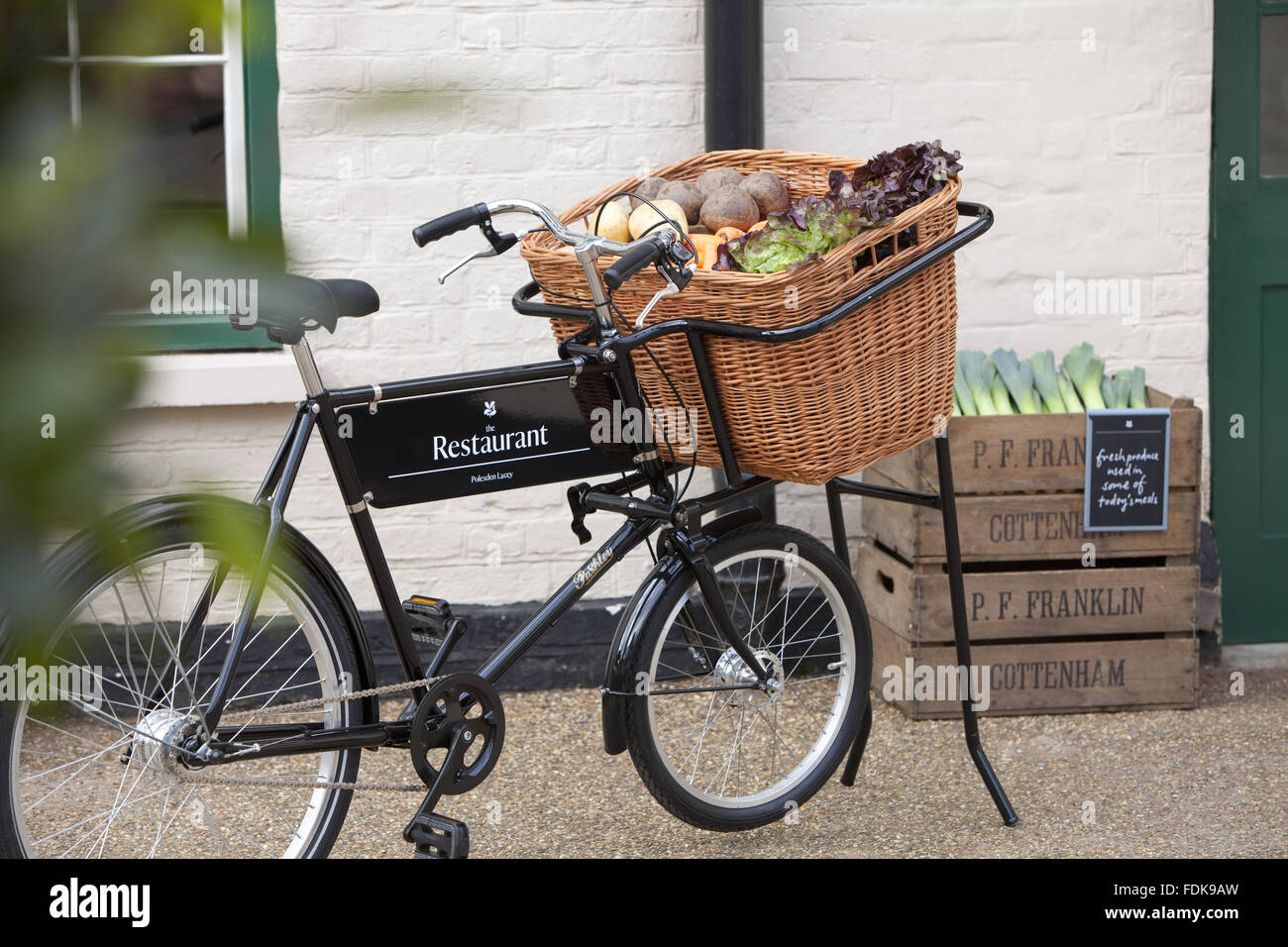 A traditional delivery bicycle with a basket on display outside ...