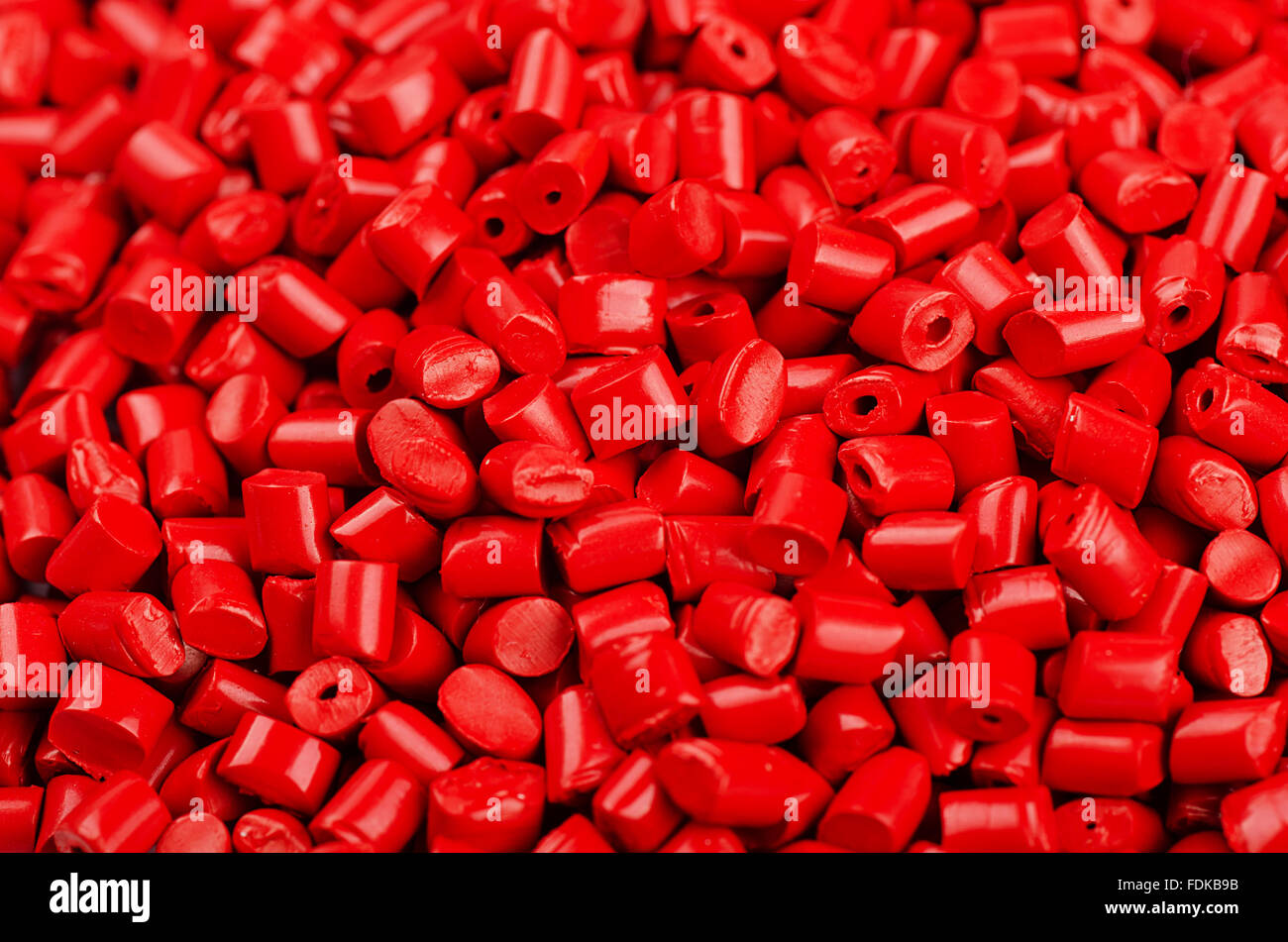 Little red plastic grains as background Stock Photo - Alamy