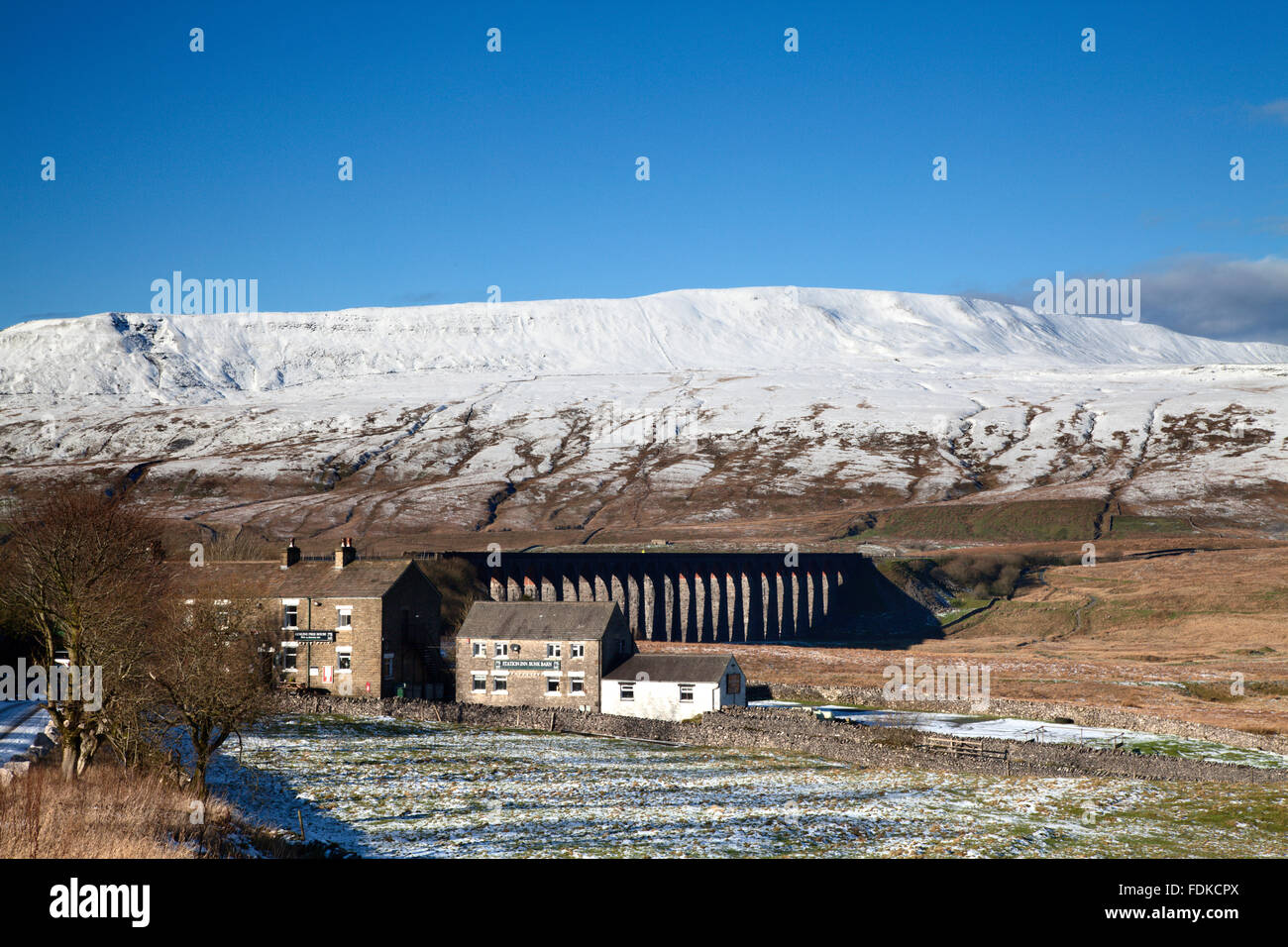 The Station Inn and Ribblehead Viaduct below the Snowcapped Peak of ...