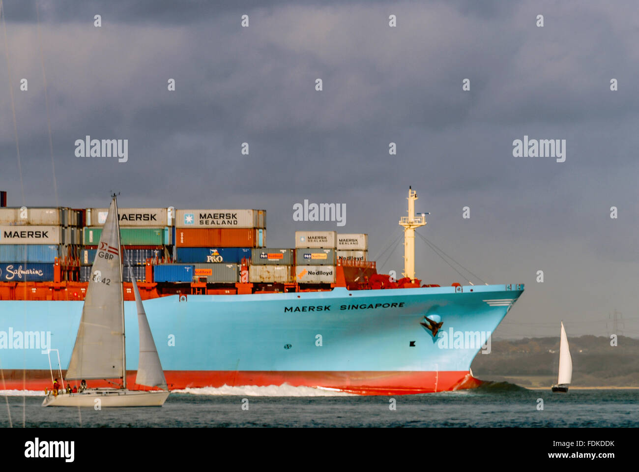 A Maersk container ship loaded with cargo negotiating the narrow ...