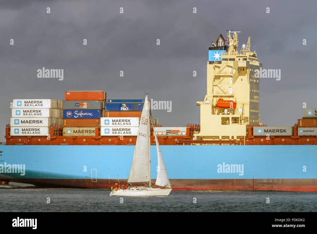 A Maersk container ship loaded with cargo negotiating the narrow ...